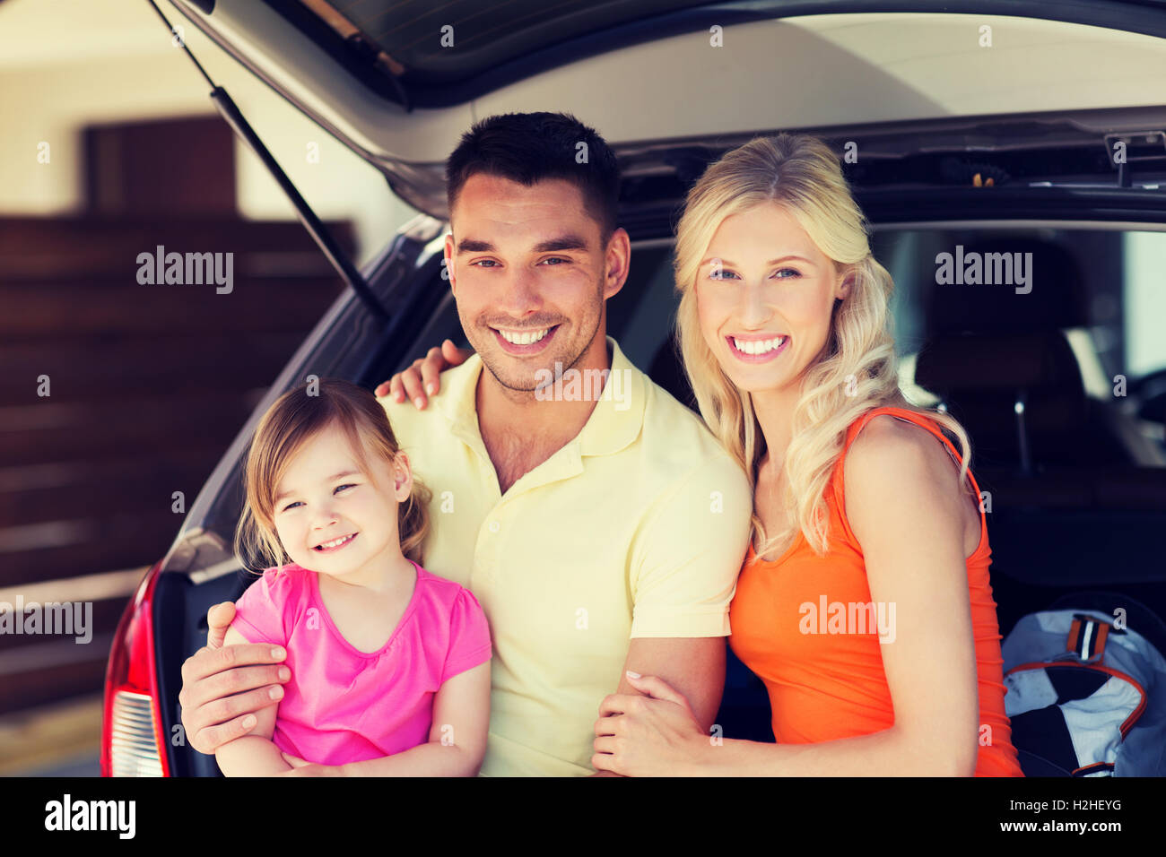 happy family with hatchback car at home parking Stock Photo - Alamy