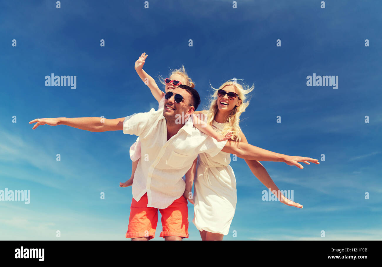 happy family having fun over blue sky background Stock Photo - Alamy