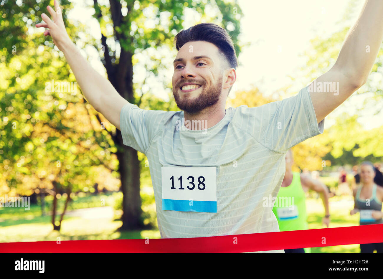 happy young male runner winning on race finish Stock Photo - Alamy