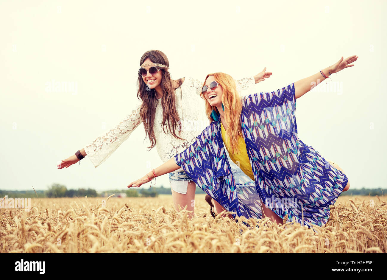 happy hippie women having fun on cereal field Stock Photo - Alamy