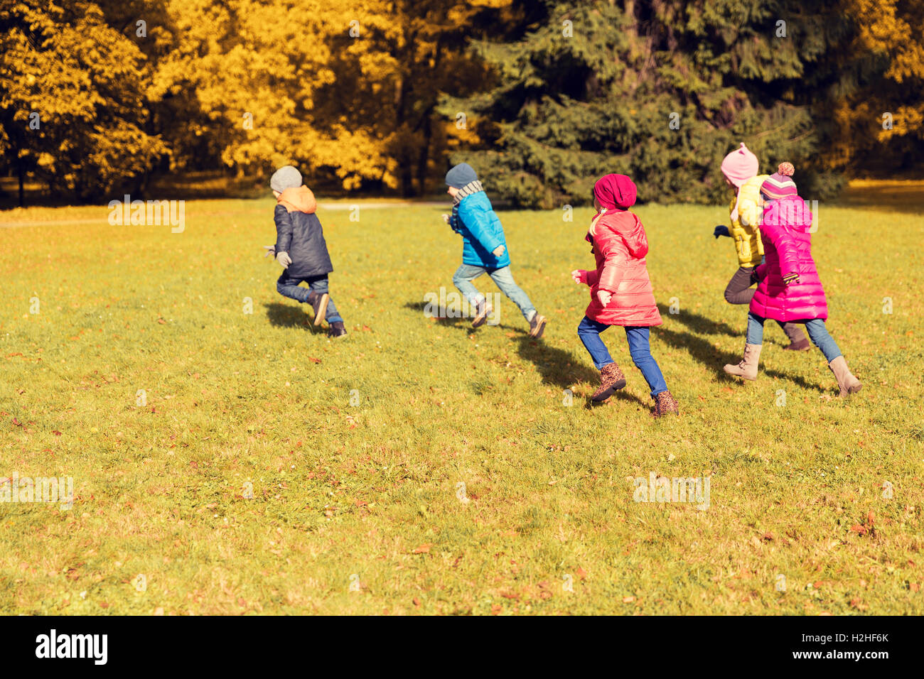 group of happy little kids running outdoors Stock Photo - Alamy