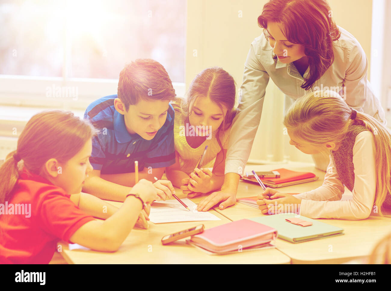 group of school kids writing test in classroom Stock Photo - Alamy