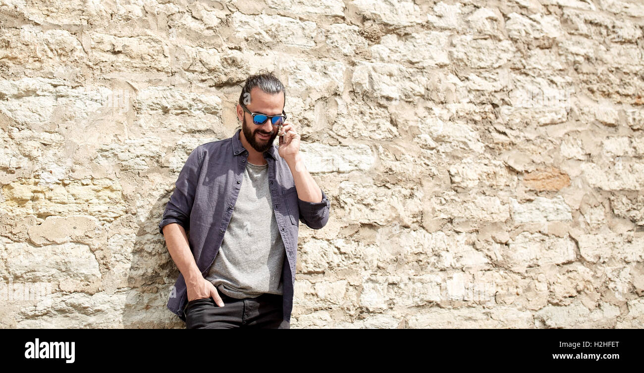 smiling man with smartphone calling on city street Stock Photo - Alamy