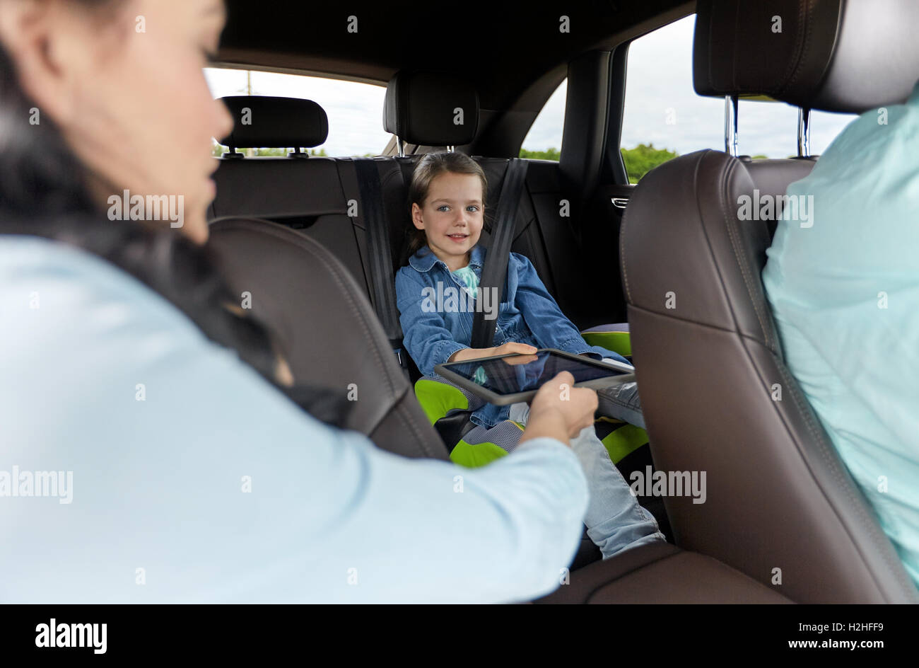 happy family with tablet pc driving in car Stock Photo - Alamy