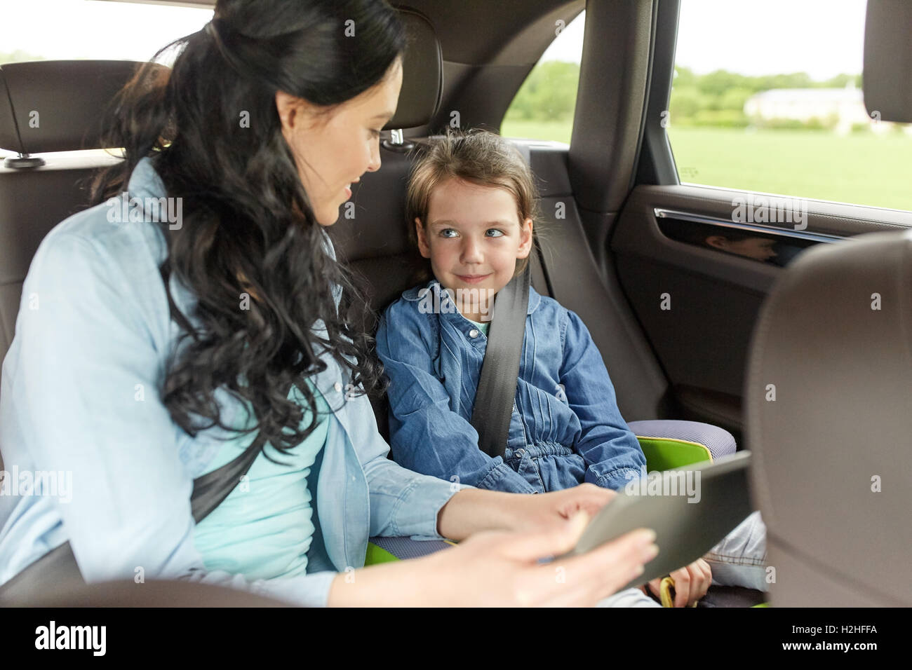 happy family with tablet pc driving in car Stock Photo - Alamy