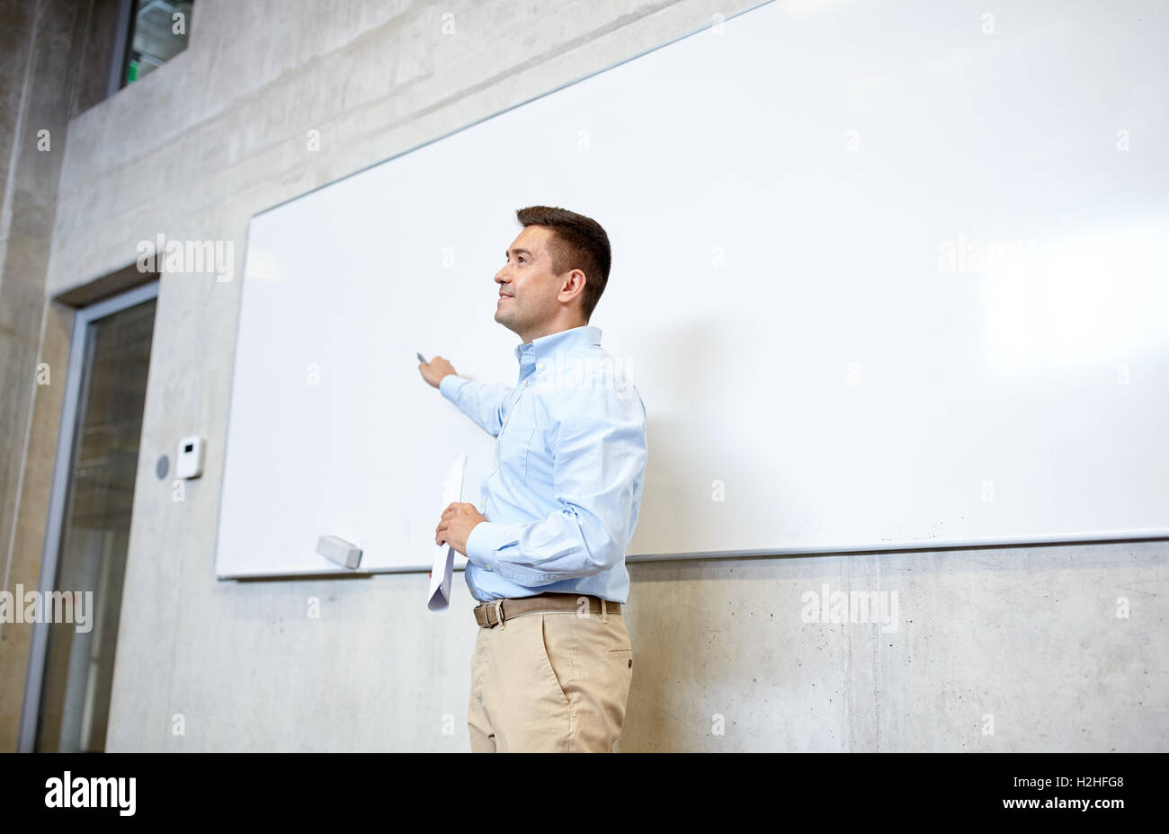 teacher pointing marker to white board at lecture Stock Photo - Alamy