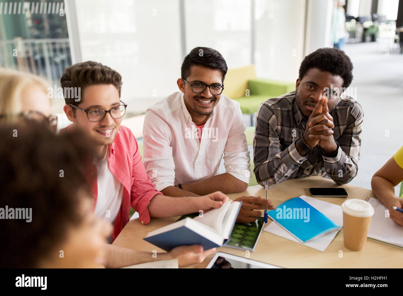 group of high school students sitting at table Stock Photo - Alamy