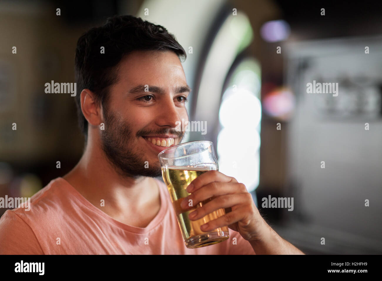 happy man drinking beer at bar or pub Stock Photo - Alamy
