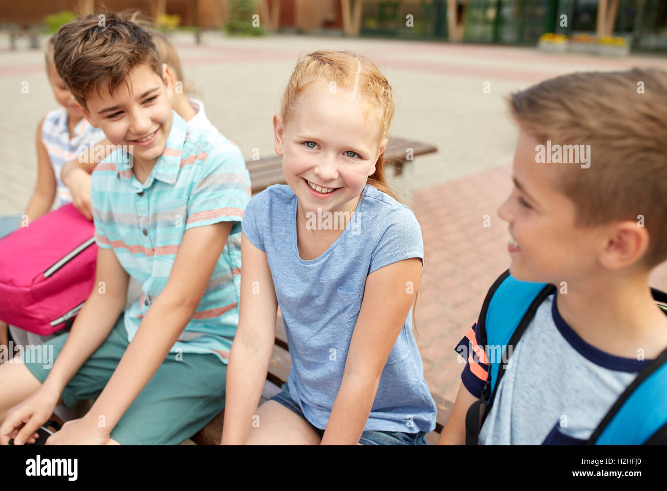 group of happy elementary school students talking Stock Photo - Alamy