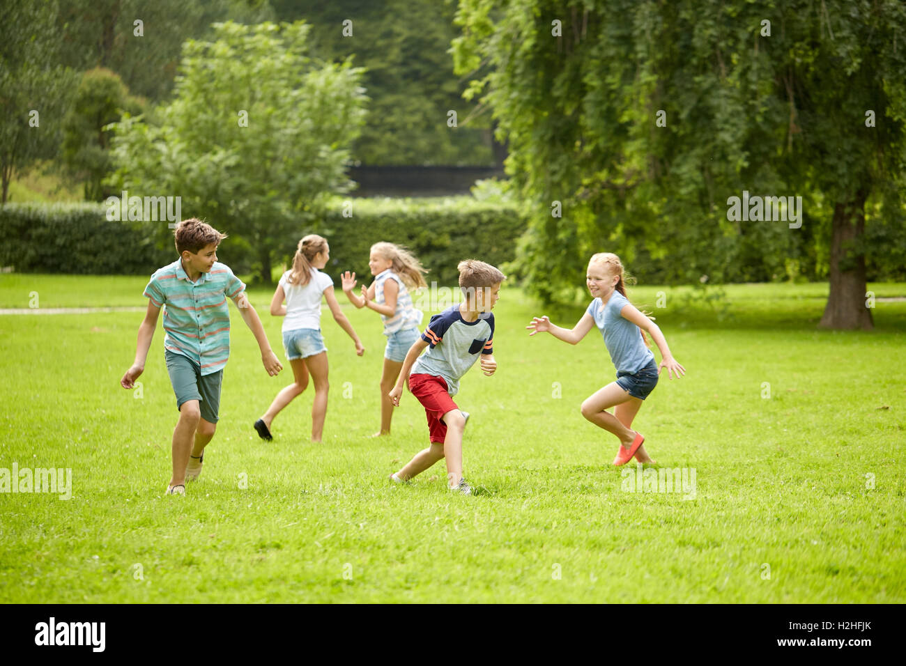 happy kids running and playing game outdoors Stock Photo - Alamy