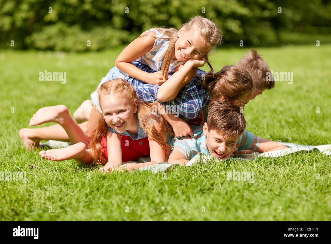 happy kids playing and having fun in summer park Stock Photo - Alamy