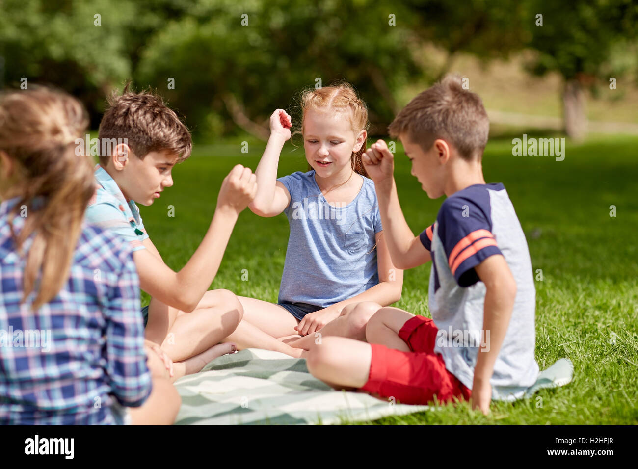happy kids playing rock-paper-scissors game Stock Photo - Alamy