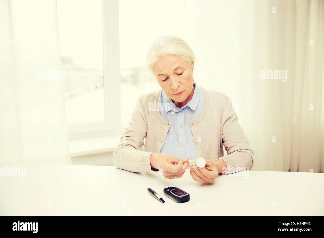 senior woman with glucometer checking blood sugar Stock Photo - Alamy