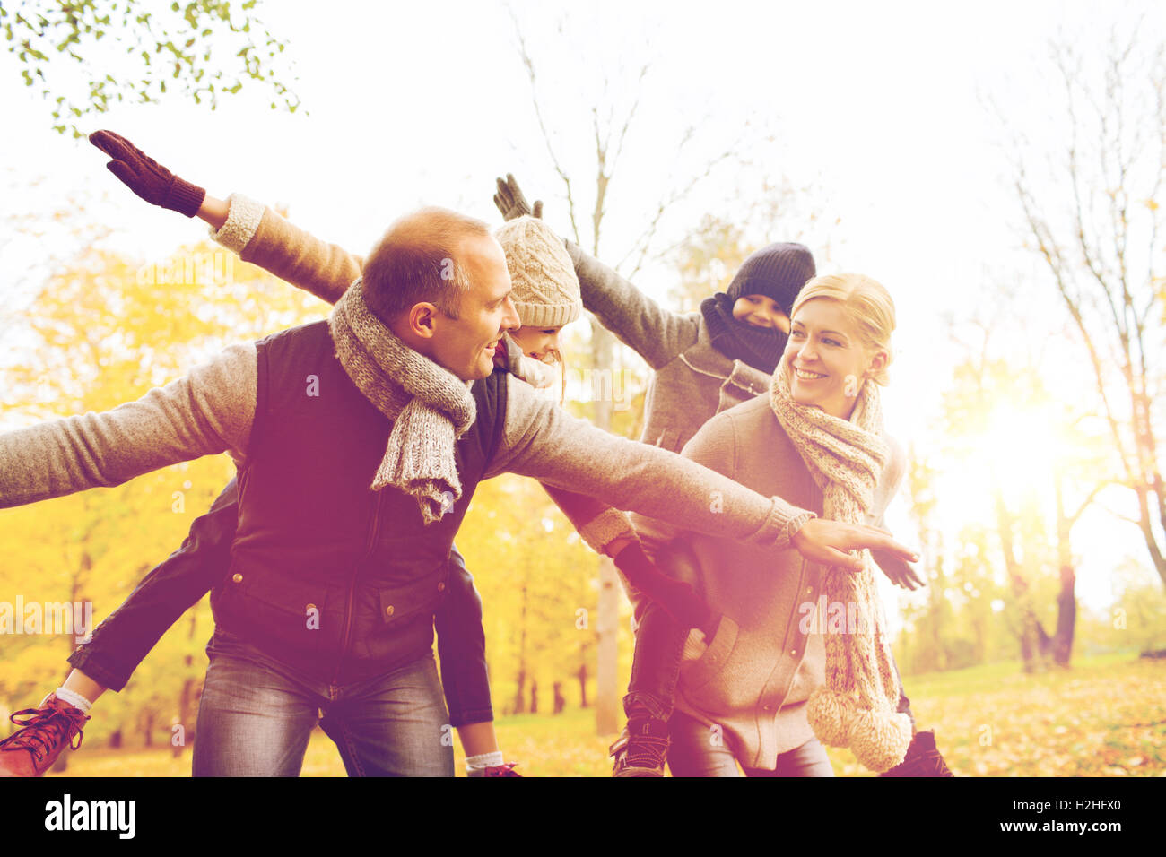 happy family having fun in autumn park Stock Photo - Alamy