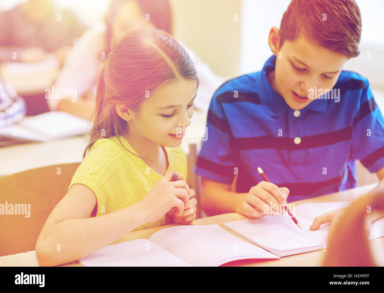 group of school kids writing test in classroom Stock Photo - Alamy