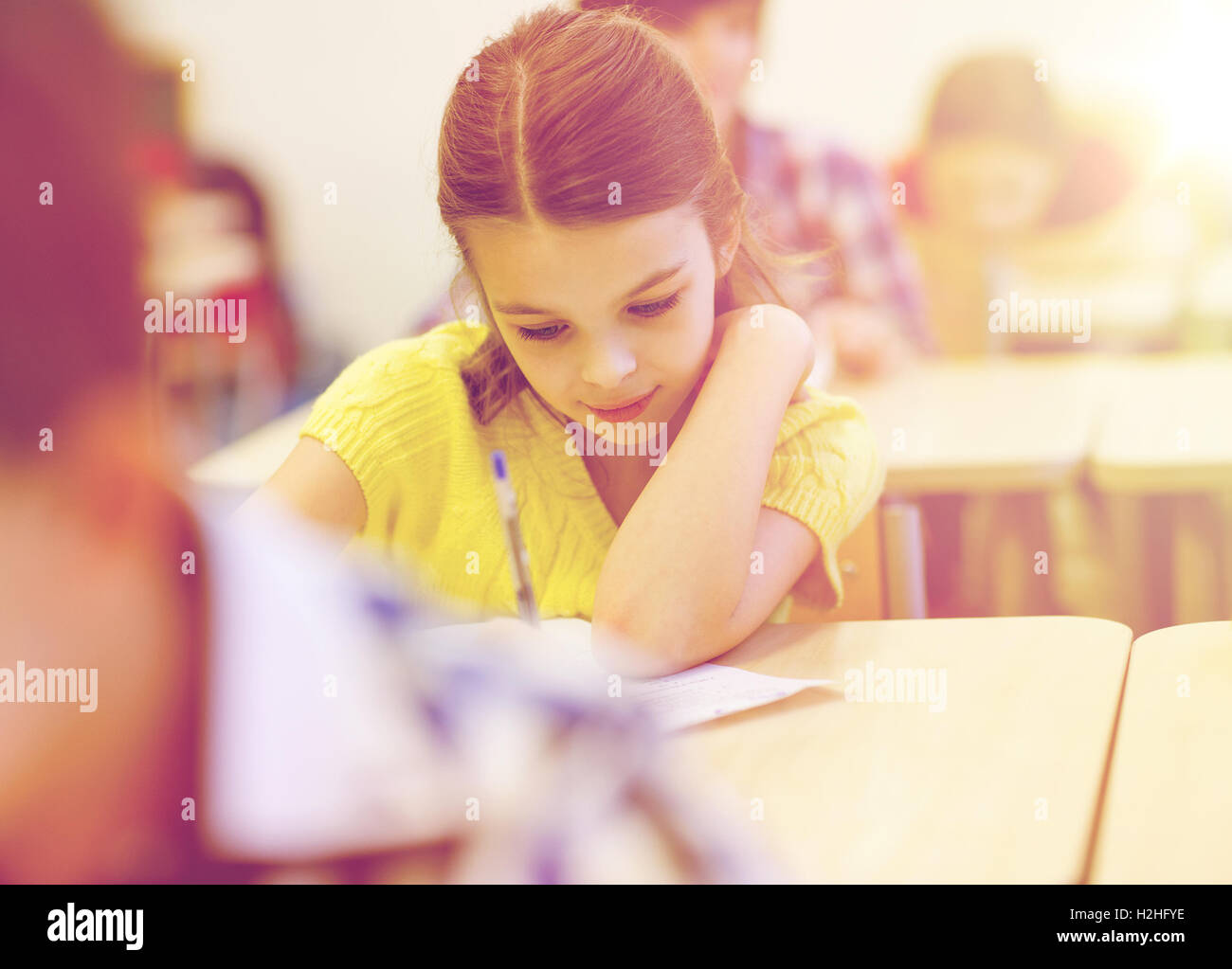 group of school kids writing test in classroom Stock Photo - Alamy