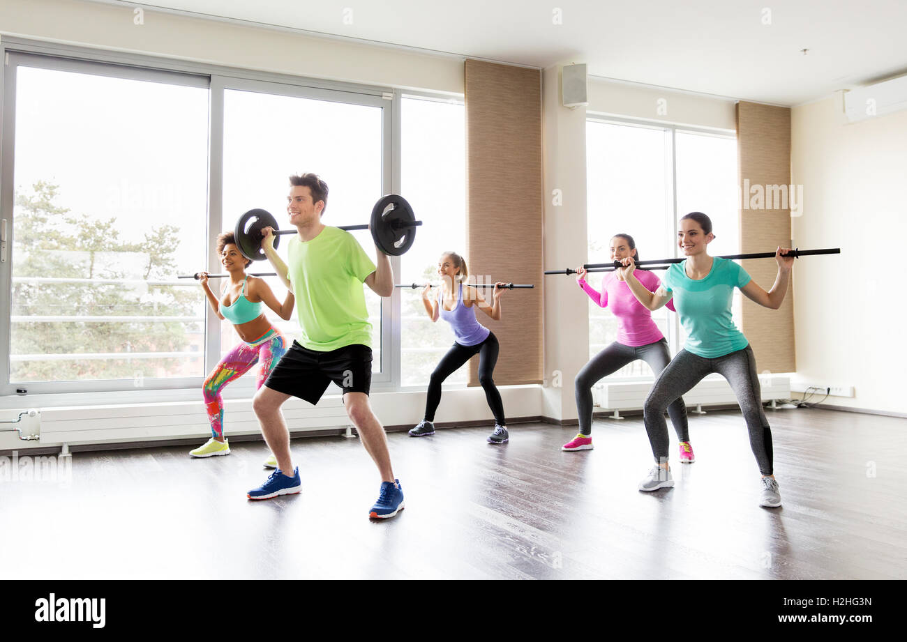 happy people exercising with barbell bars in gym Stock Photo - Alamy
