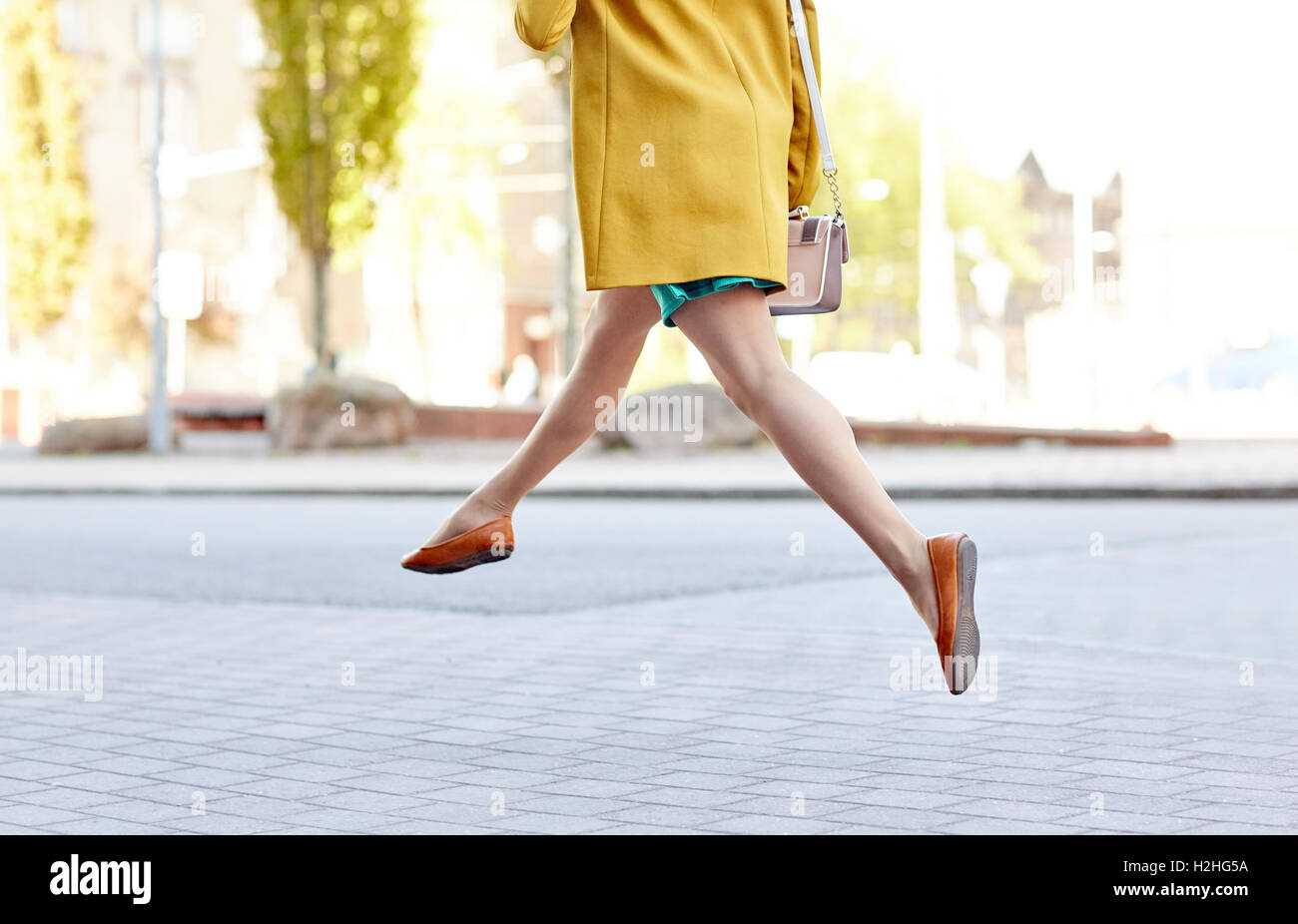 young woman or teenage girl legs on city street Stock Photo - Alamy