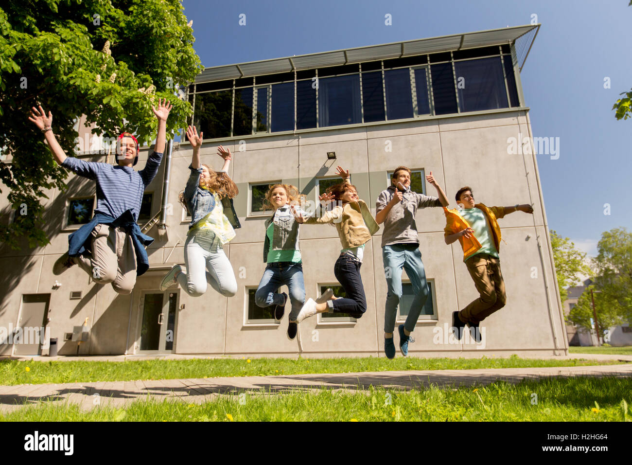 happy teenage students or friends jumping outdoors Stock Photo - Alamy