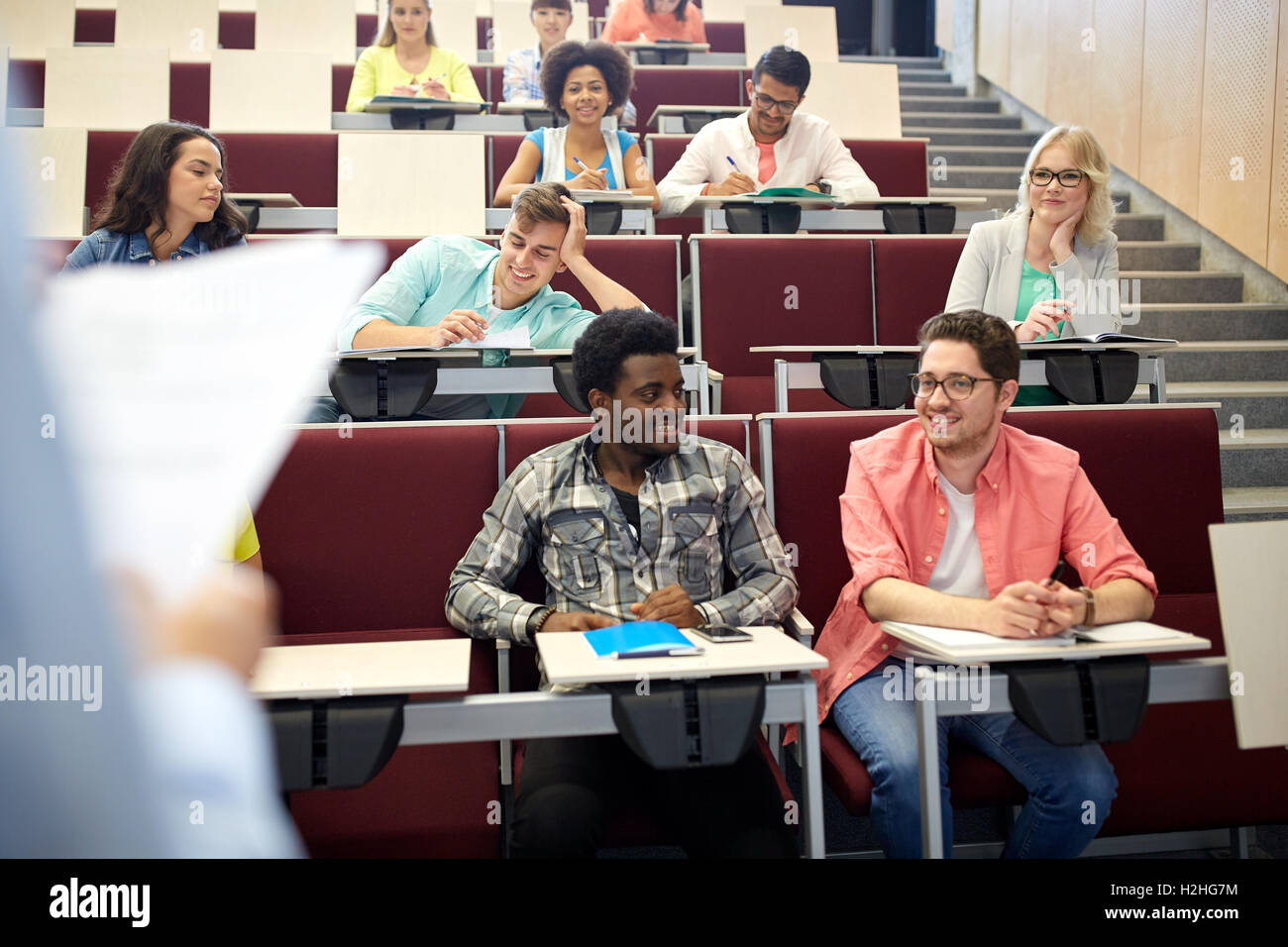 group of students with notebooks at lecture hall Stock Photo - Alamy