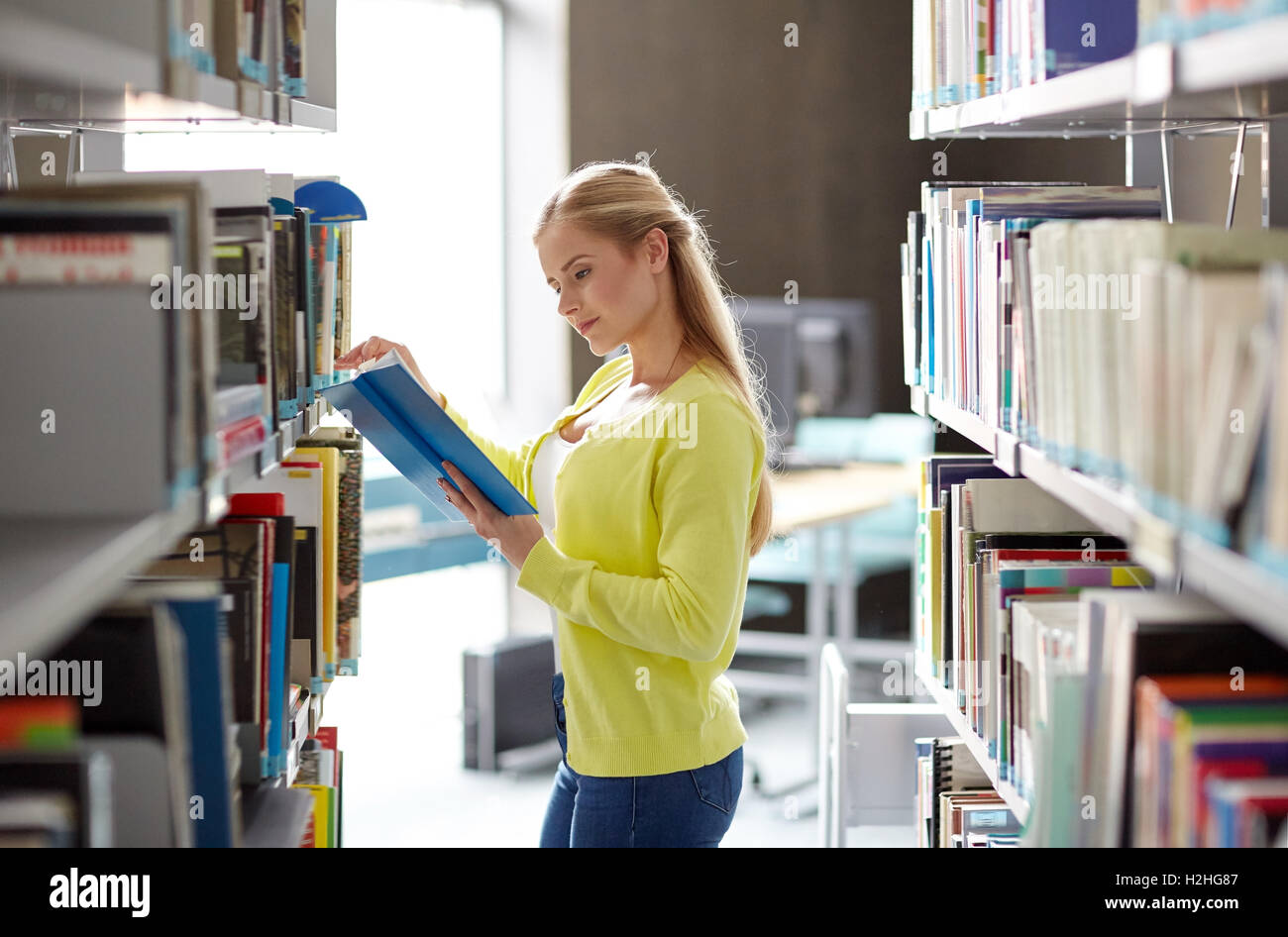 high school student girl reading book at library Stock Photo - Alamy