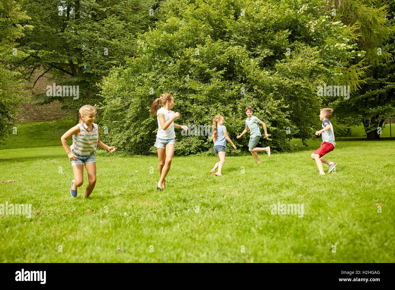 happy kids running and playing game outdoors Stock Photo - Alamy