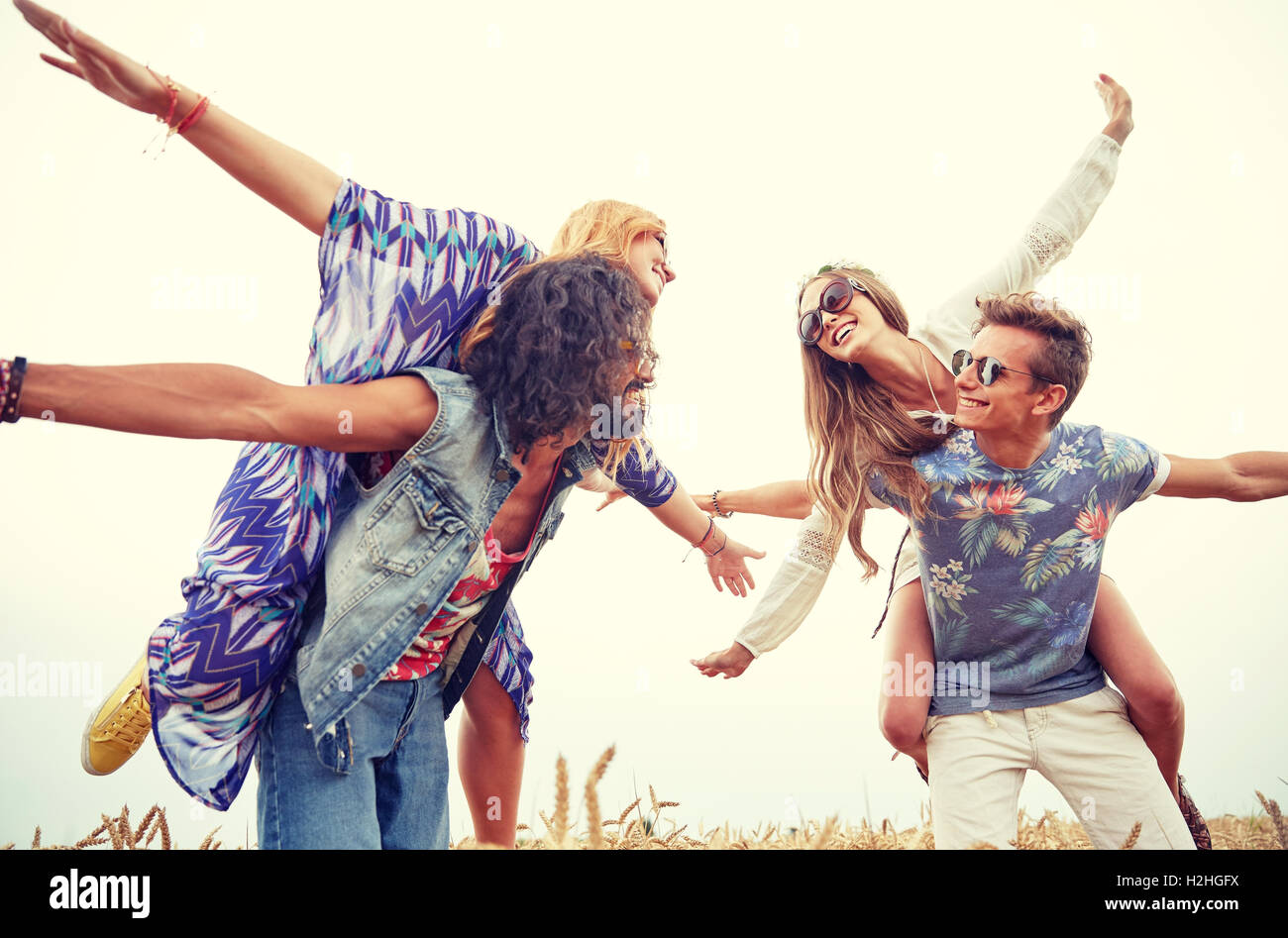 happy hippie friends having fun on cereal field Stock Photo - Alamy