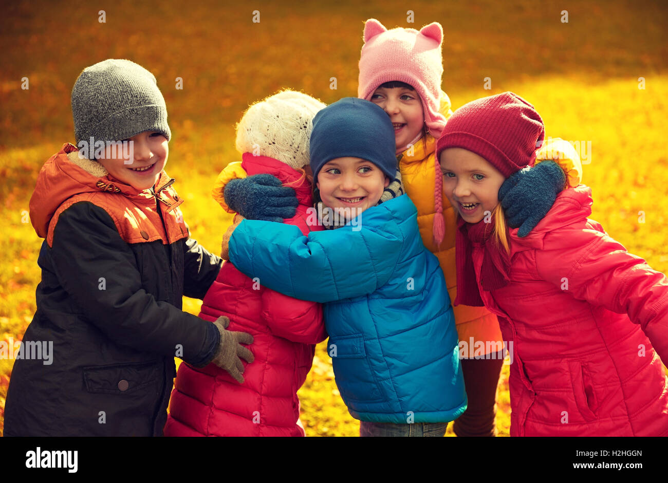 group of happy children hugging in autumn park Stock Photo - Alamy