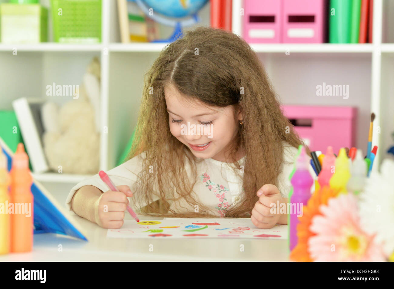 Little girl drawing at class Stock Photo - Alamy
