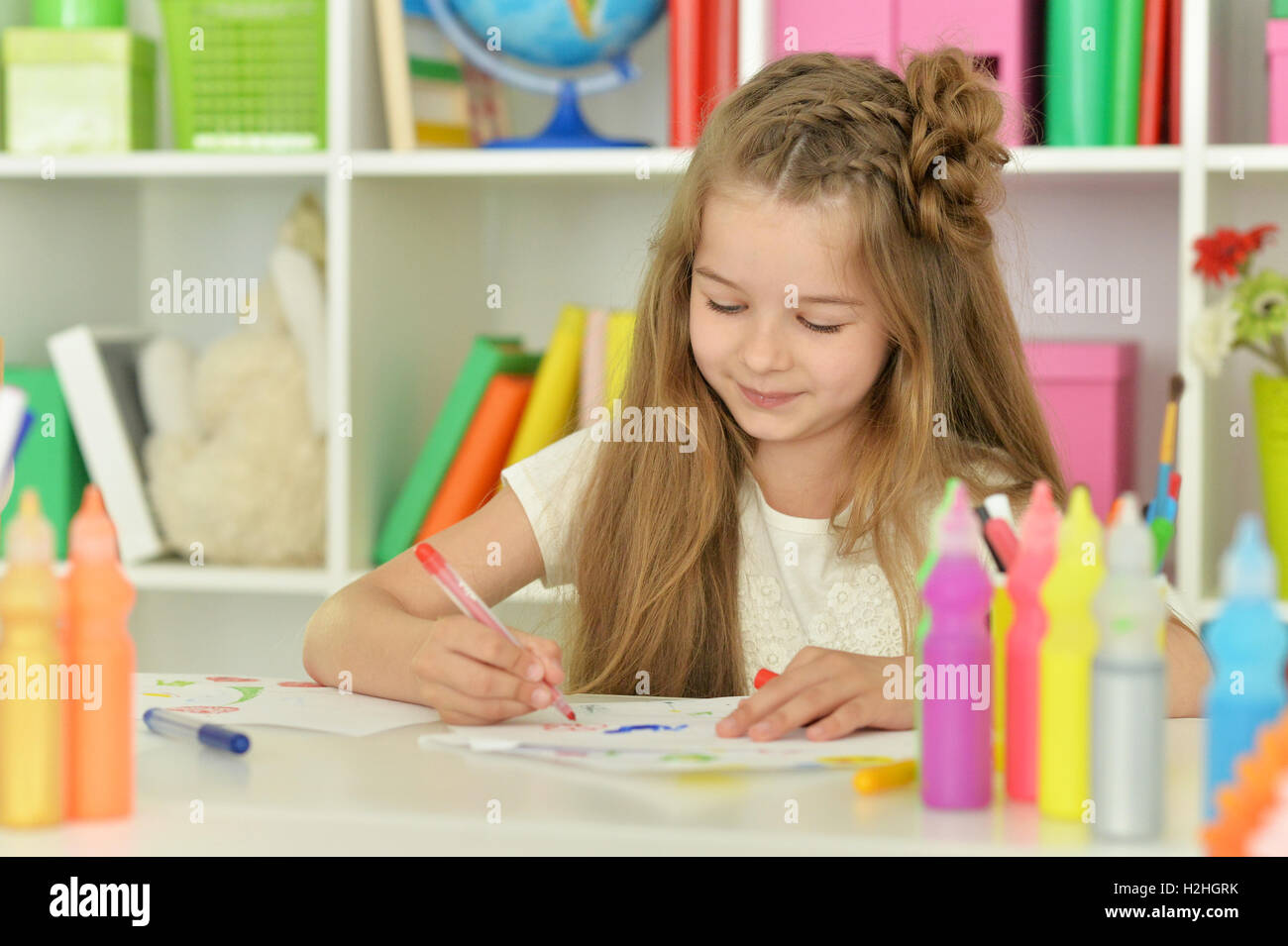 Little girl drawing at class Stock Photo - Alamy