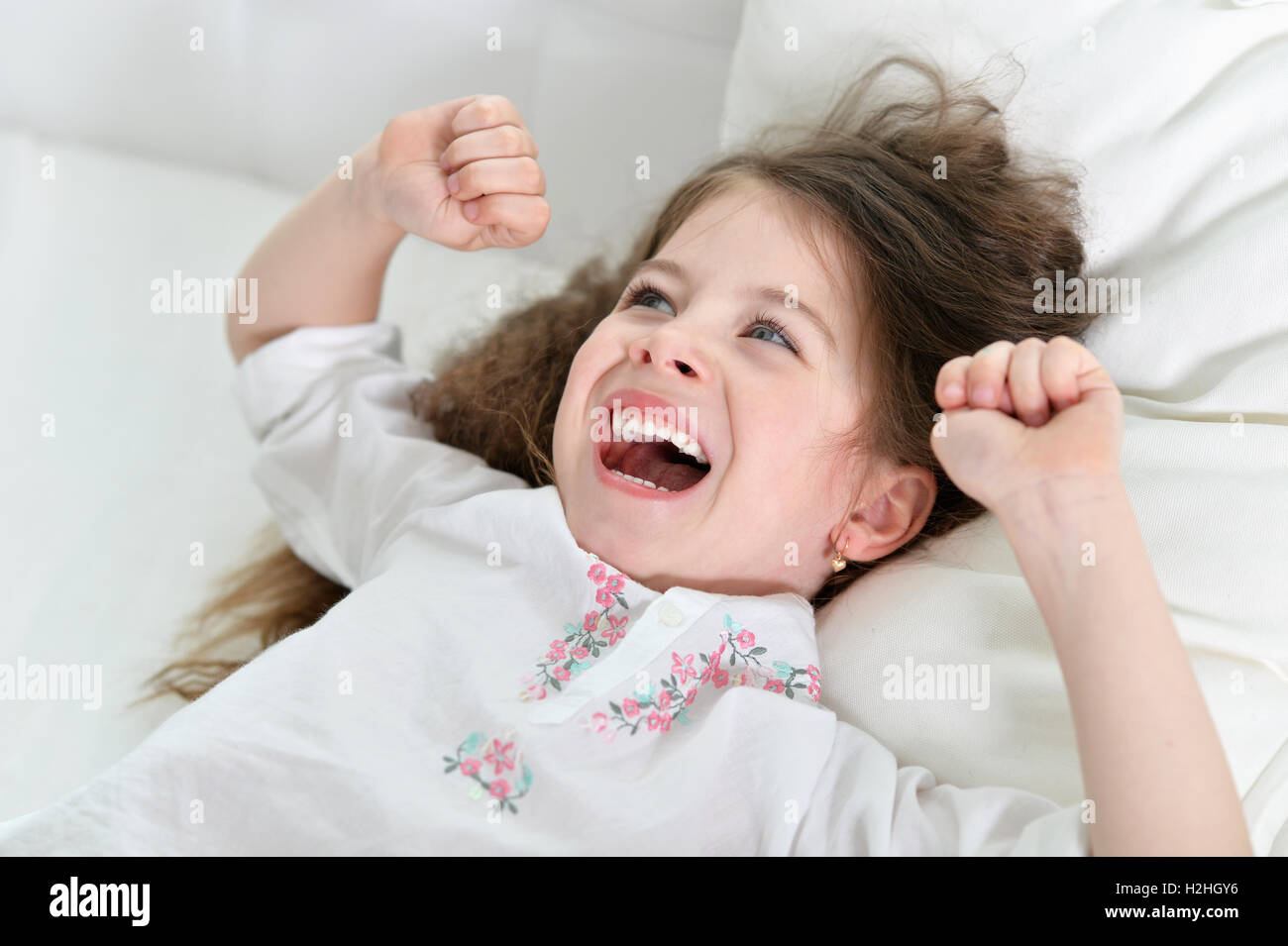 Adorable little girl awaked up Stock Photo - Alamy