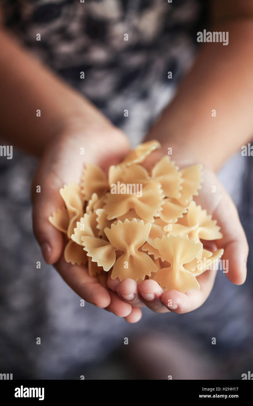 Handful of farfalle italian pasta Stock Photo - Alamy