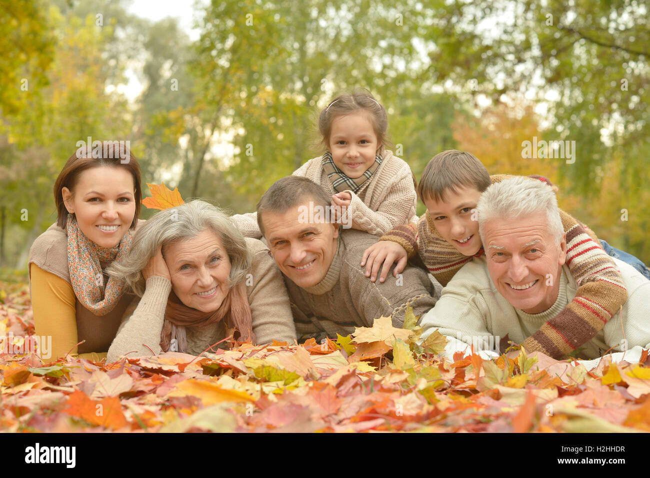 Happy family in autumn forest Stock Photo - Alamy