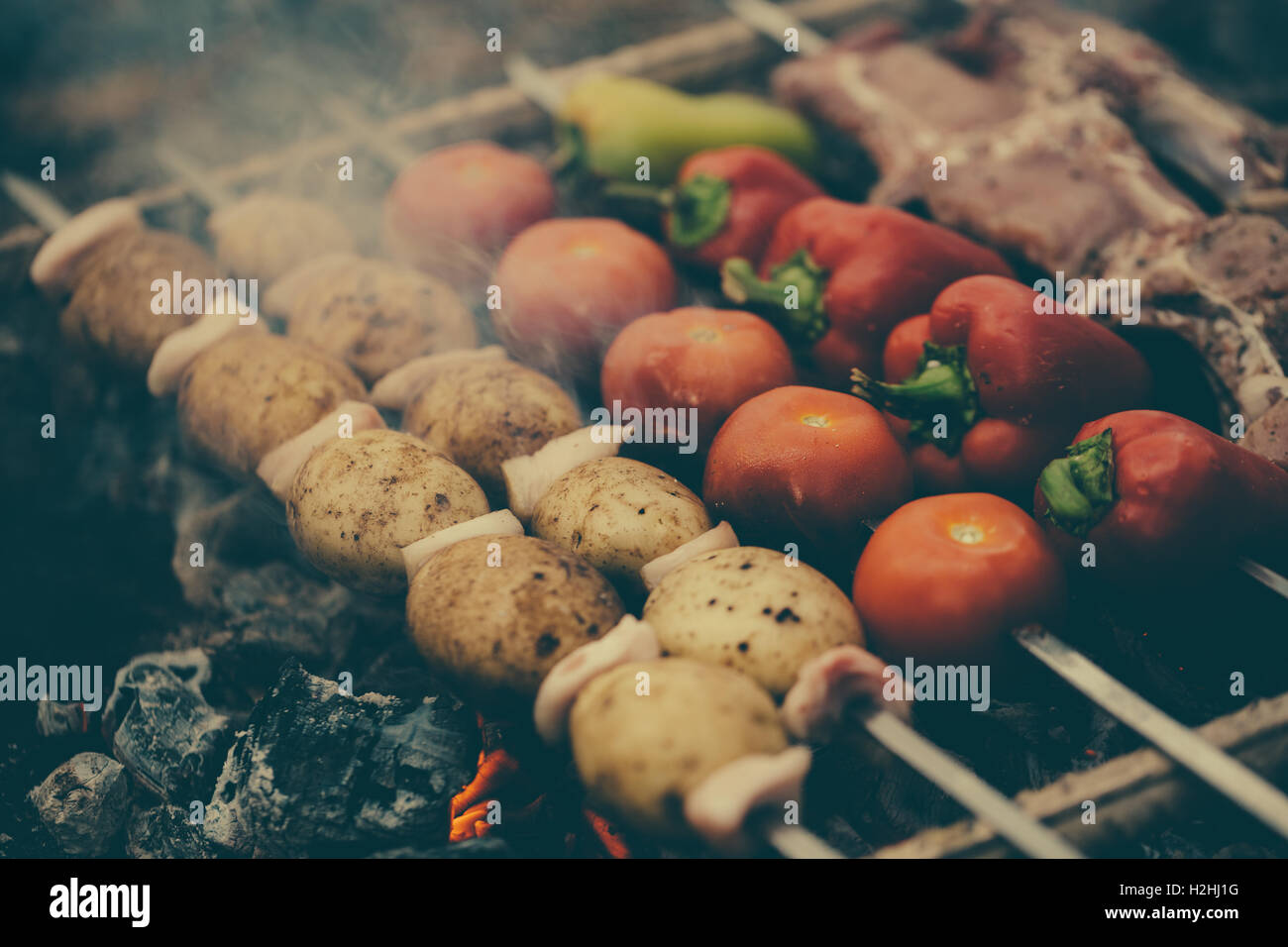 Meat and vegetables are roasted on coals Stock Photo - Alamy