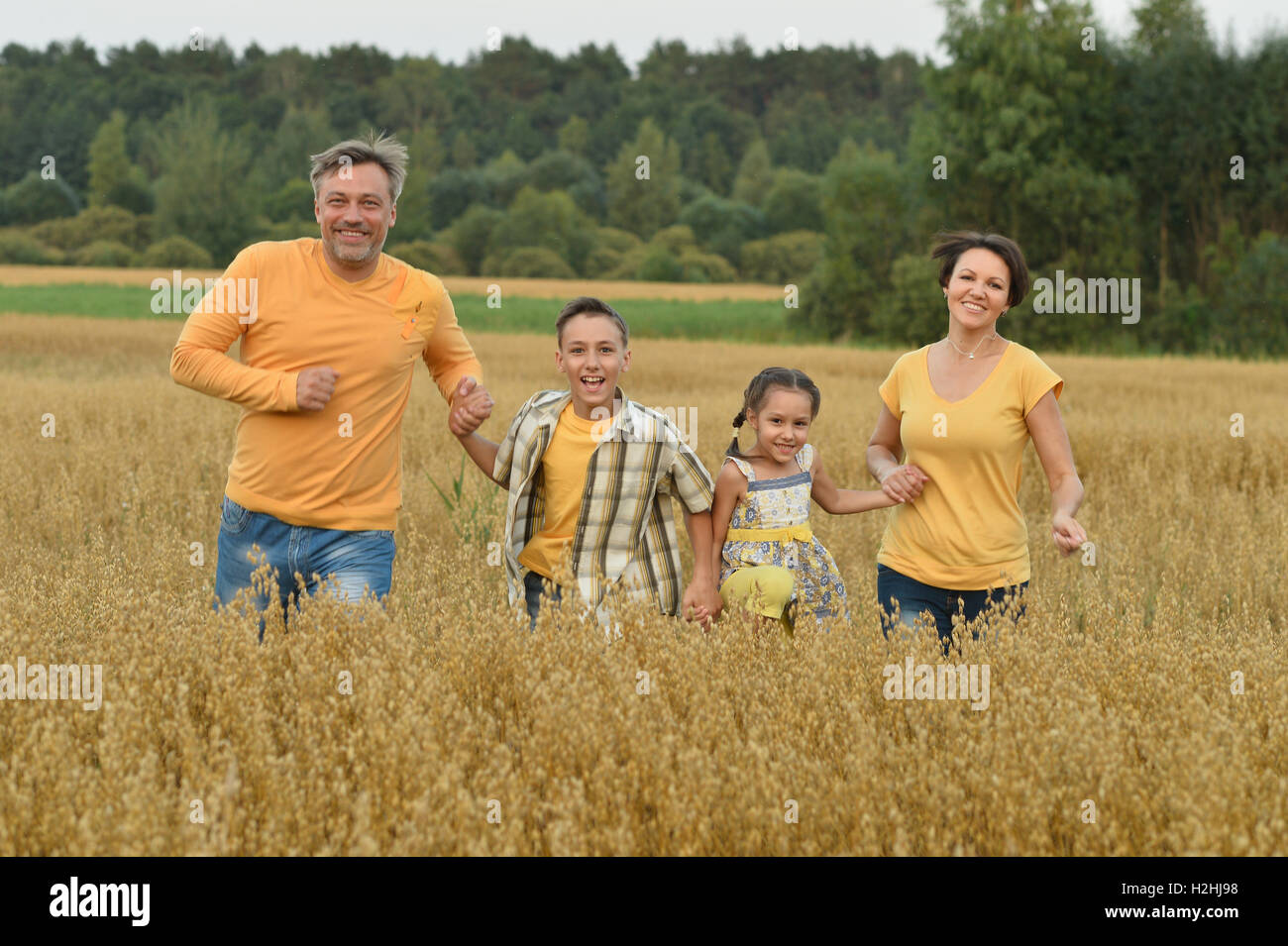 happy family at field Stock Photo - Alamy