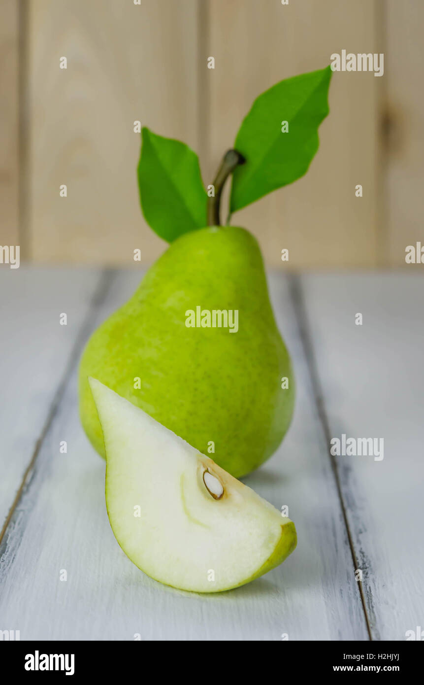 One and a slice green pears over white background Stock Photo - Alamy