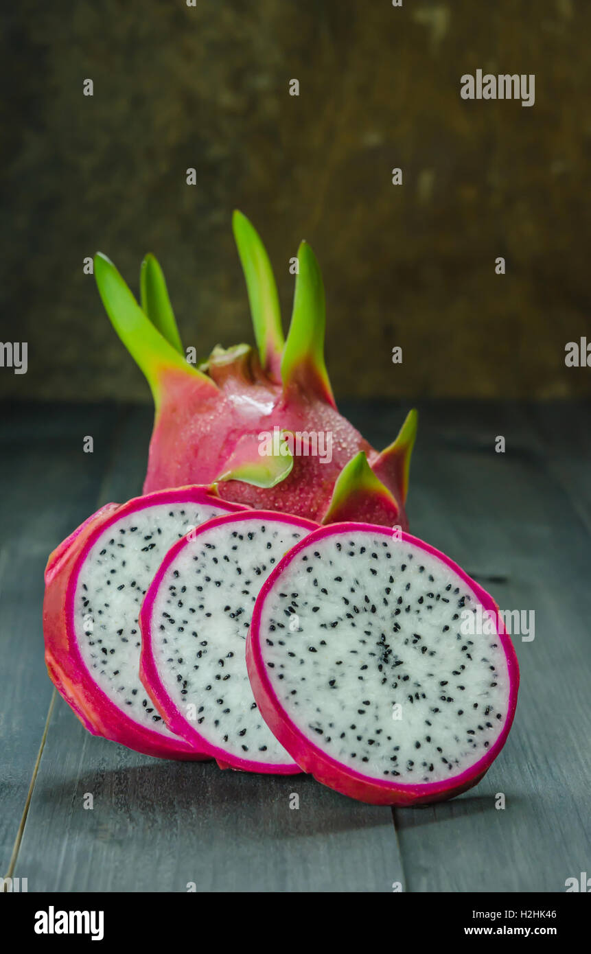 Ripe Dragon fruit or Pitaya with slice on wooden background , still ...