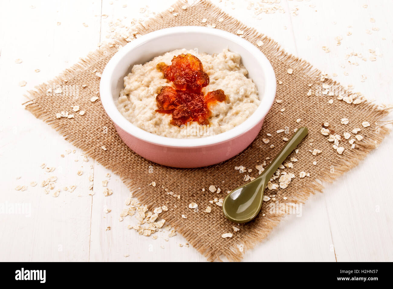 fresh made warm porridge with double cream and orange marmalade in a ...