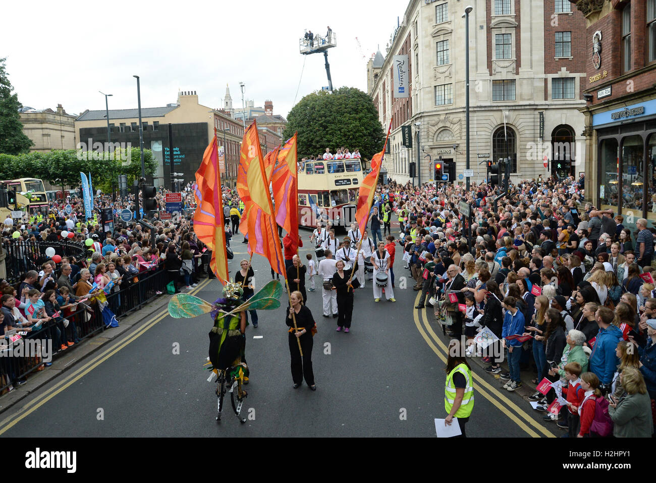 The parade of open top buses makes its way through the crowds during ...
