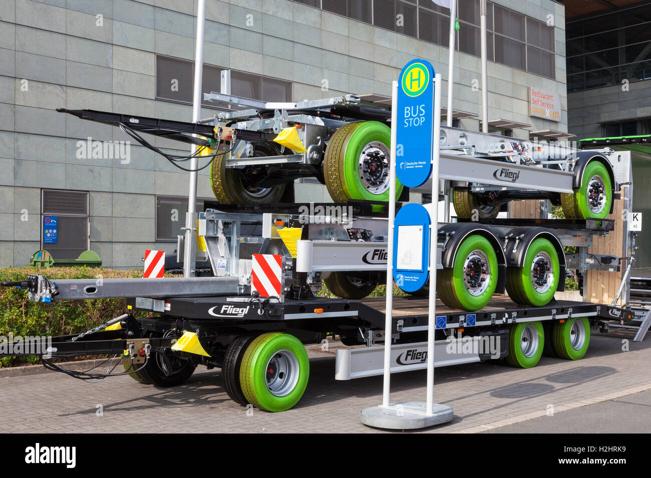 Stack of Fliegl trailers with green painted tires at the IAA 2016 Stock ...