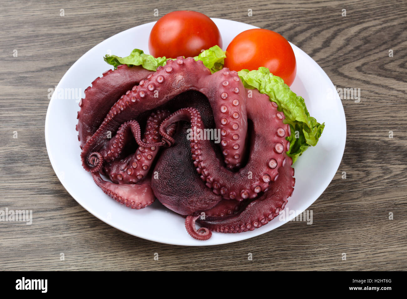Boiled octopus ready for eat with salad leaves Stock Photo - Alamy