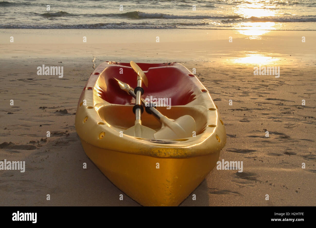 a kayak canoe boat on the beach during sunset Stock Photo - Alamy