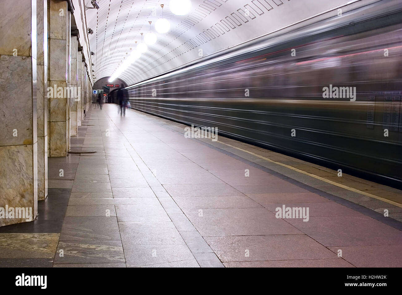 Subway station in Moscow with a floor of stone, columns and train ...