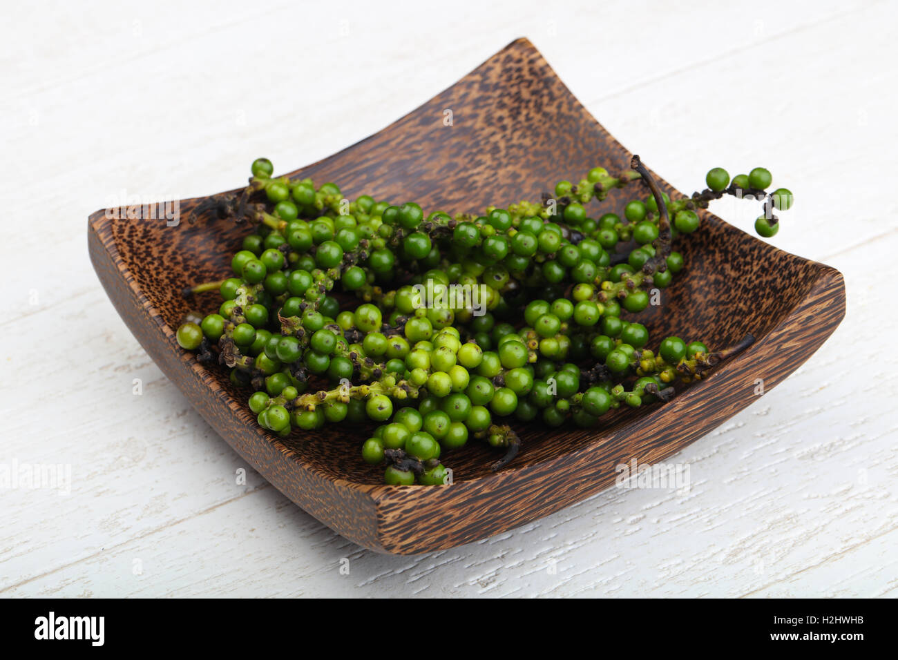 Green pepper corn on the branch in plate Stock Photo - Alamy