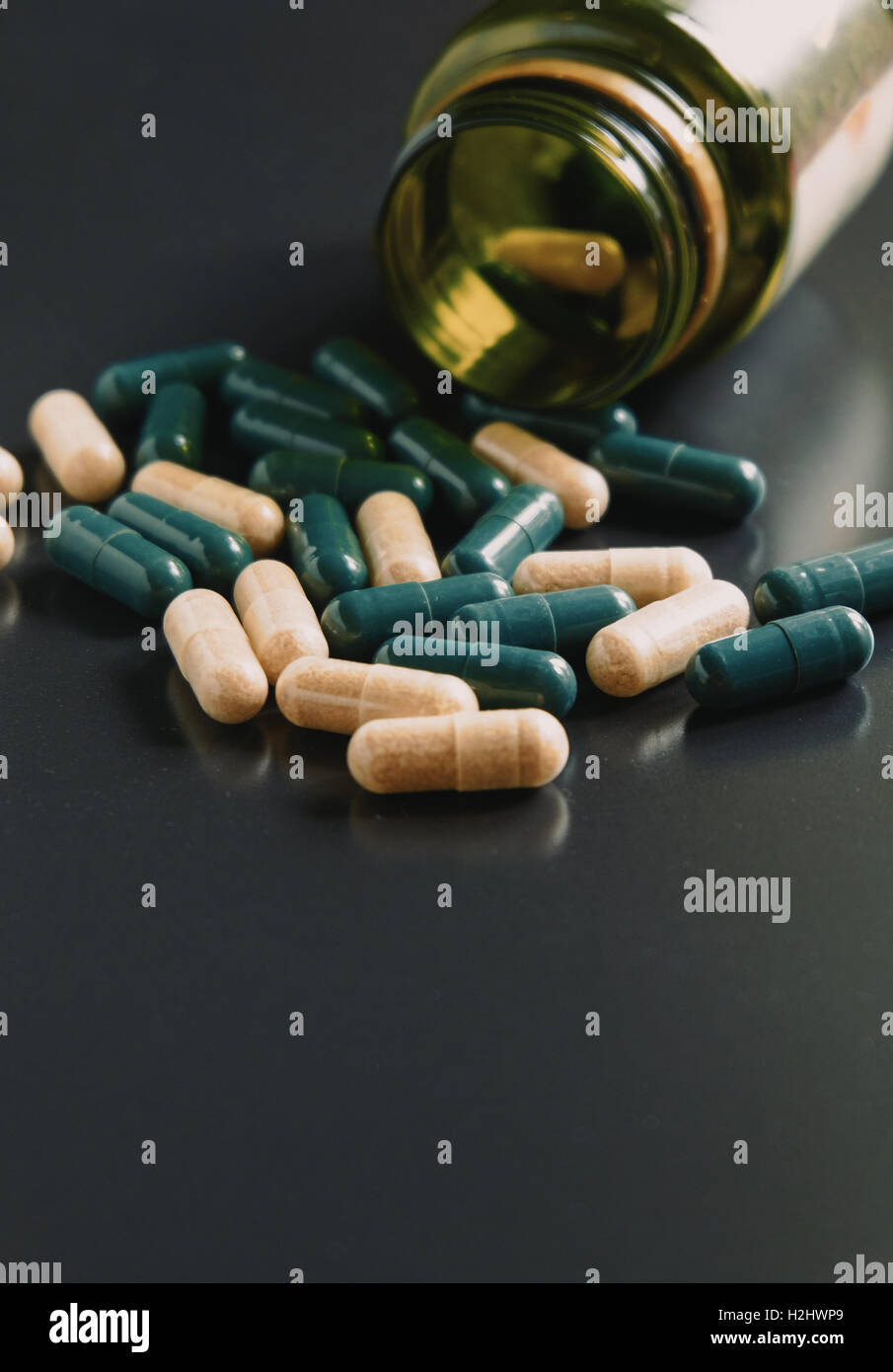 Closeup of medical capsules or pills of drug. A lot of two-color pills ...