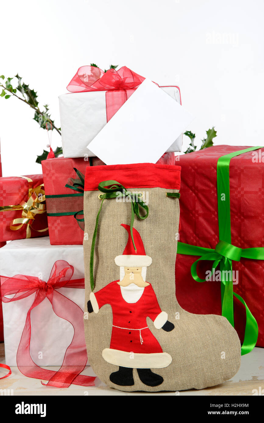 the Christmas gift boxes with boot of Santa Claus Stock Photo - Alamy