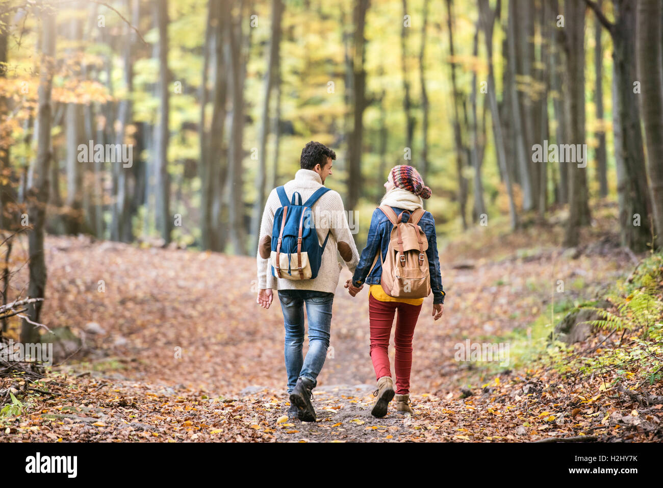 Beautiful couple on a walk in autumn forest Stock Photo - Alamy