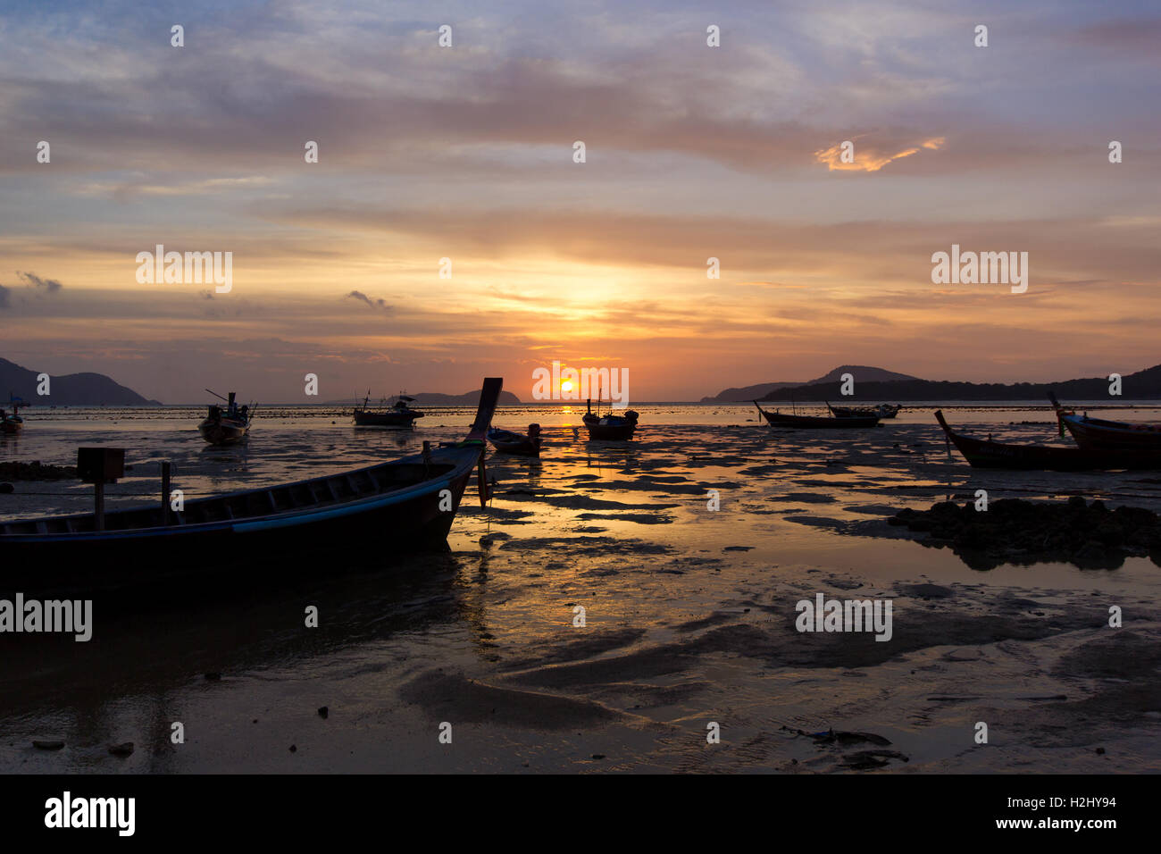 Beautiful sunrise in Rawai Phuket island Thailand with Long tailed boat ...