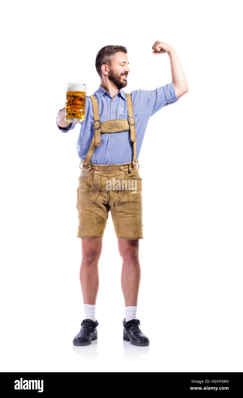 Man in bavarian clothes, holding beer, showing biceps Stock Photo - Alamy
