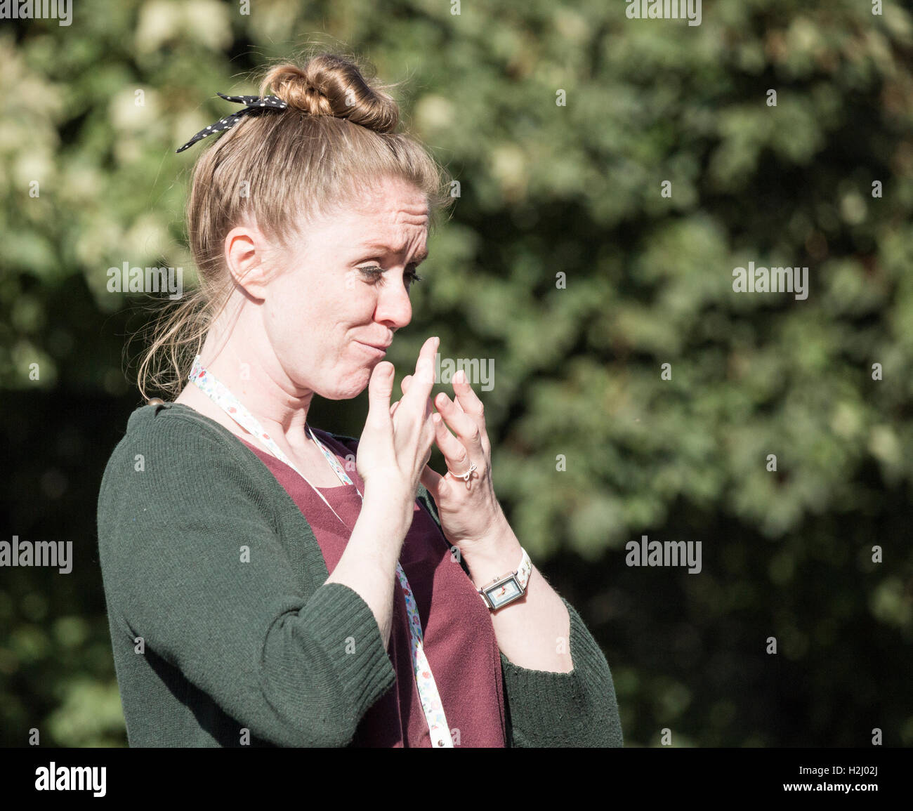 Female signer using sign language for people with impaired hearing at ...